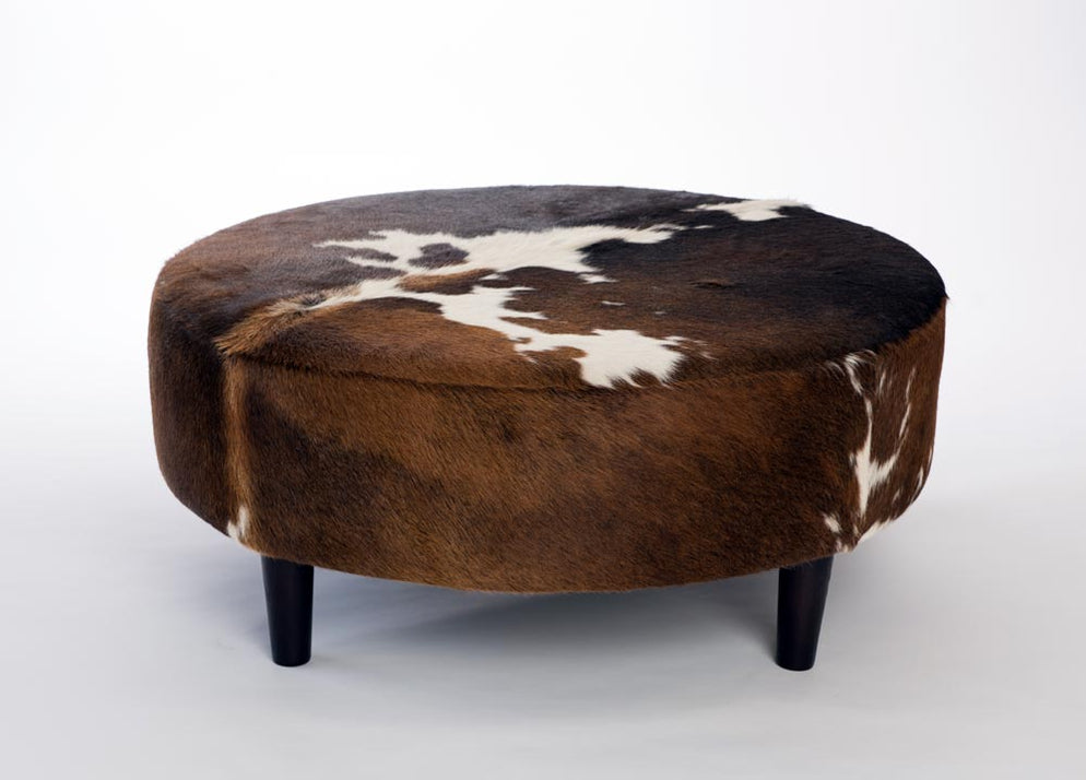 Round Brown Cowhide Ottoman with Wood Legs — Gorgeous Creatures