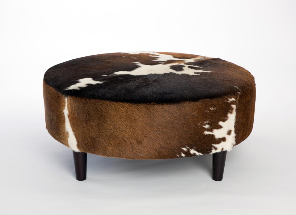 Round Brown Cowhide Ottoman with Wood Legs — Gorgeous Creatures