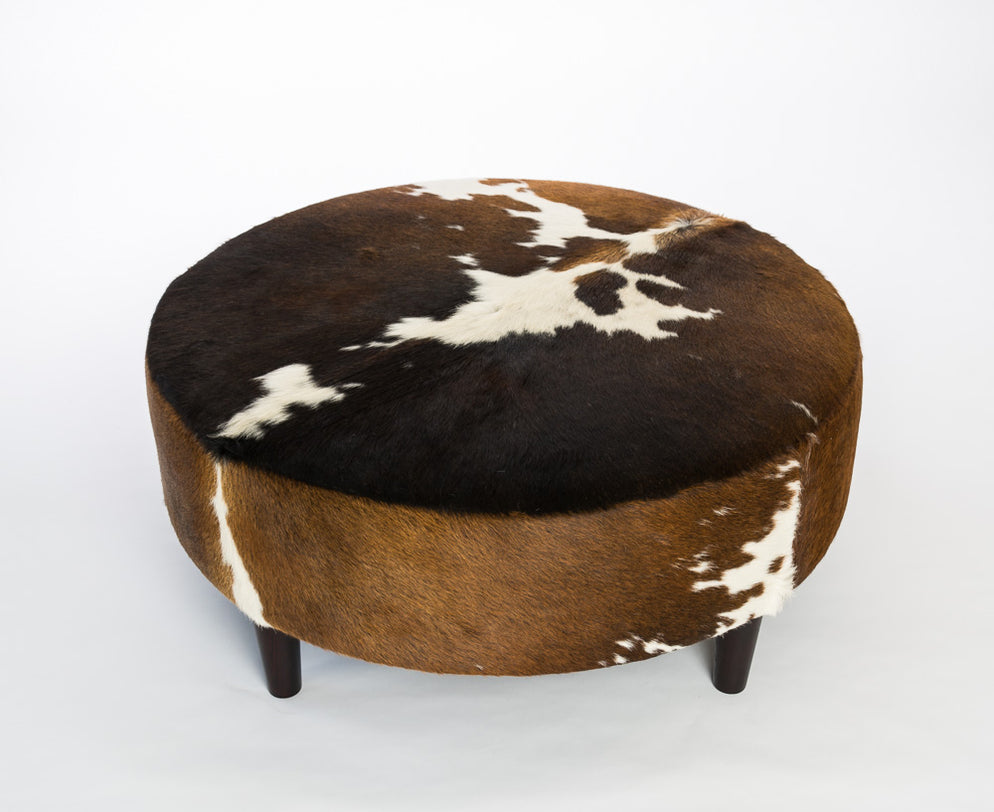 Round Brown Cowhide Ottoman with Wood Legs — Gorgeous Creatures